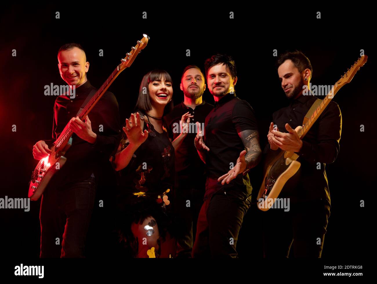 Smiling. Musician's band portrait isolated on dark studio background in ...