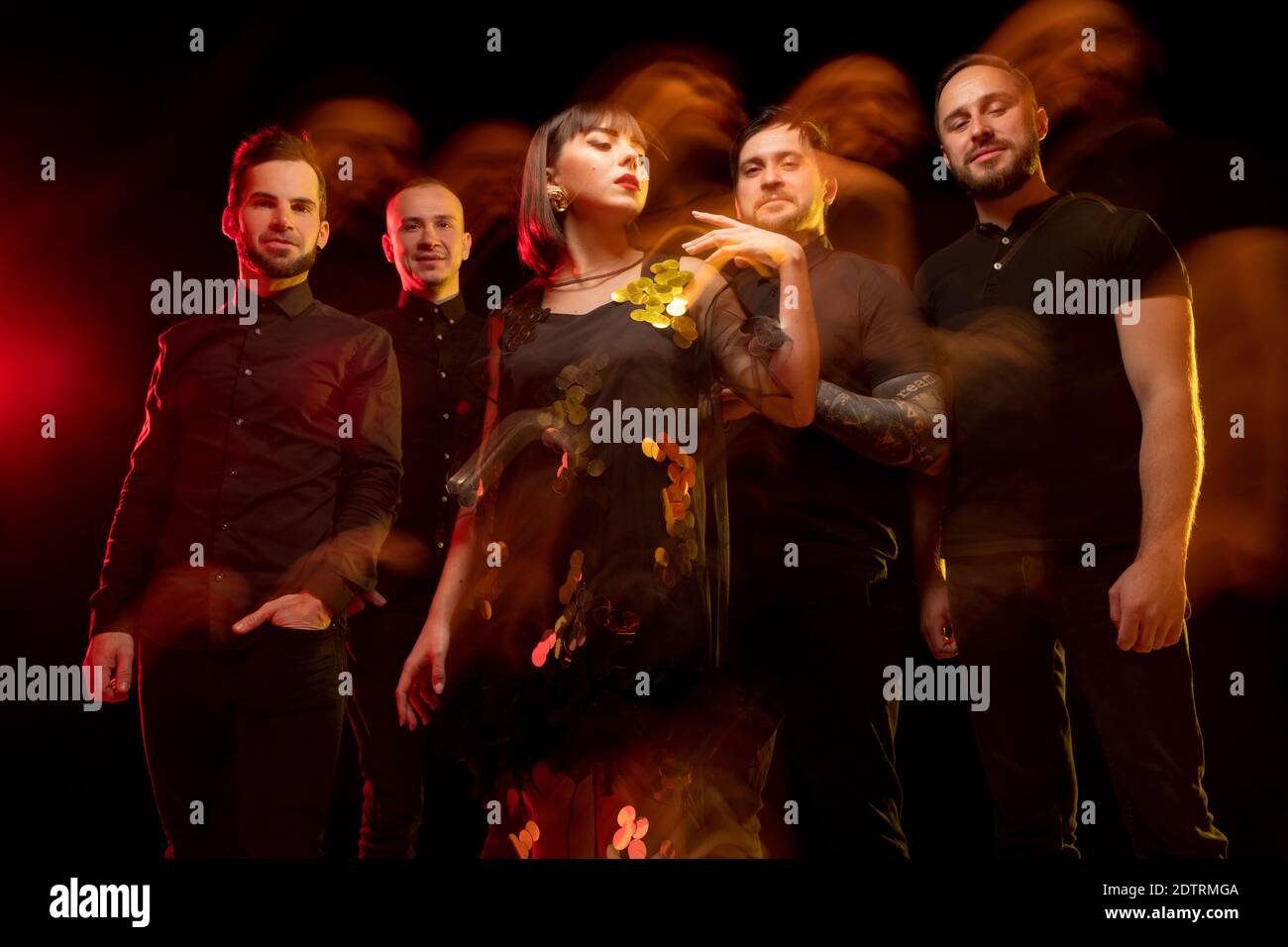 Shadows. Musician's band portrait isolated on dark studio background in ...