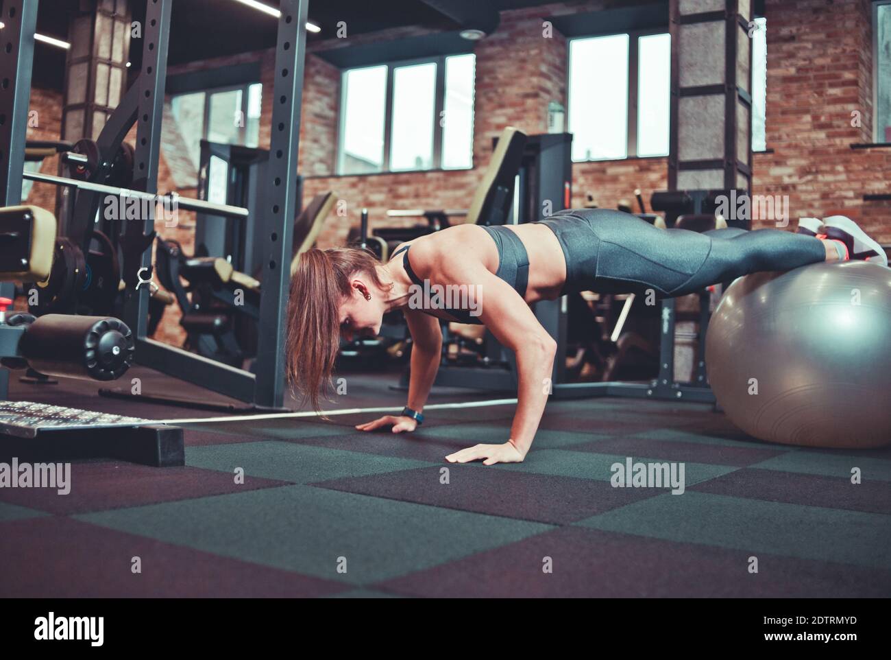Girl in sportswear training on fitball in gym. Sport, fitness training ...