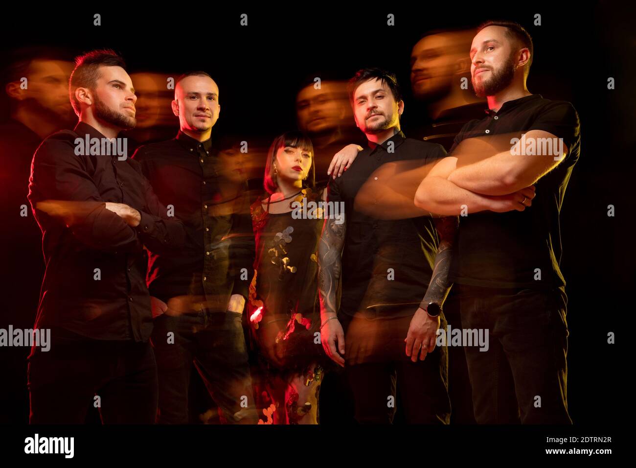 Shadows. Musician's band portrait isolated on dark studio background in ...