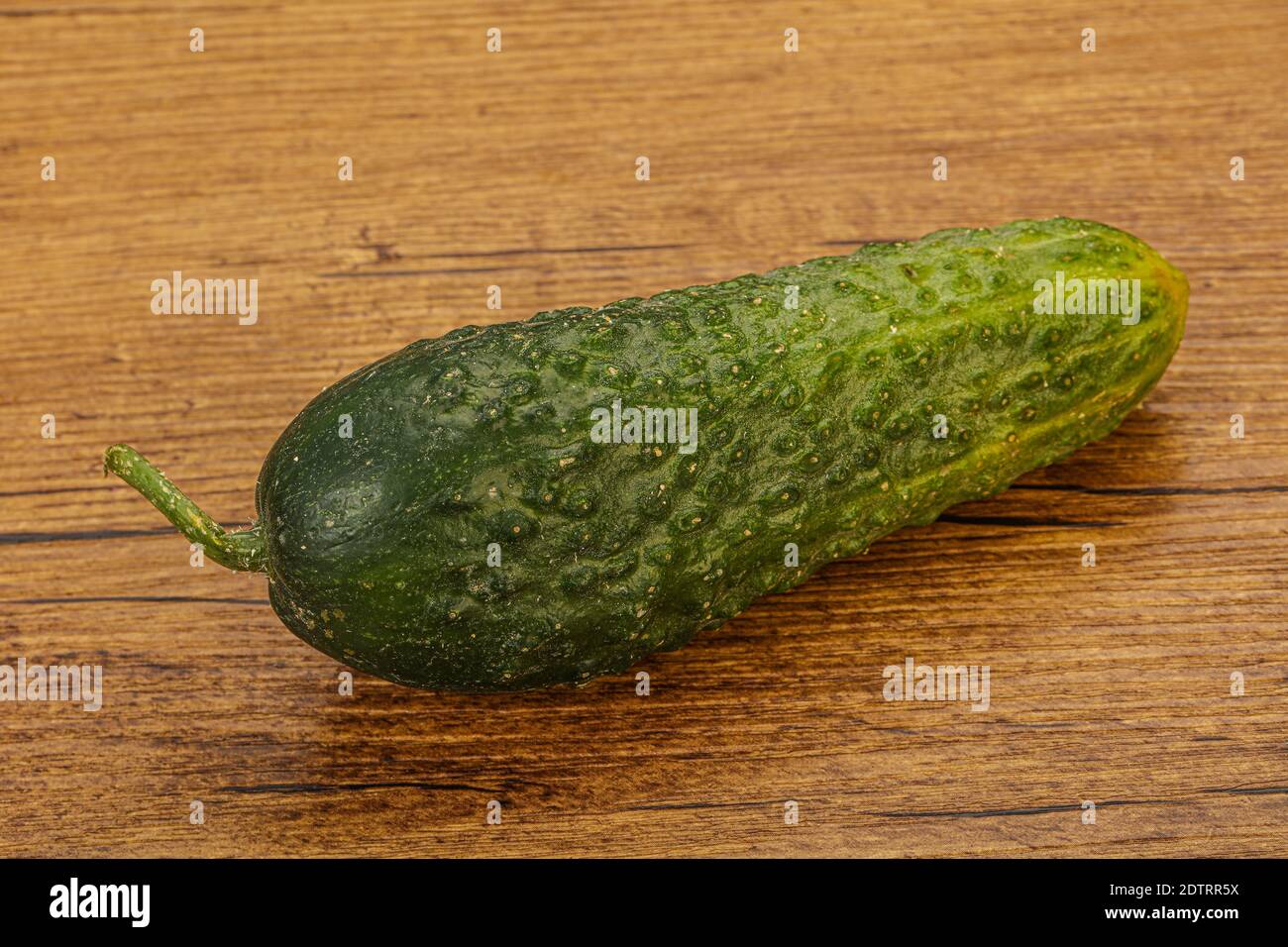 Green ripe fresh one cucumber over background Stock Photo - Alamy