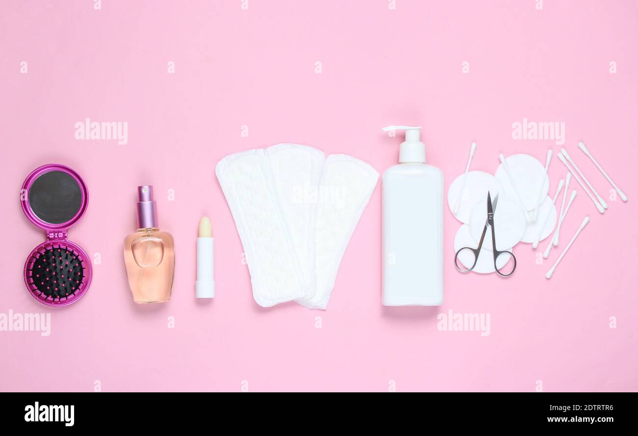 Women's beauty and hygiene products on pink pastel background. Perfume ...