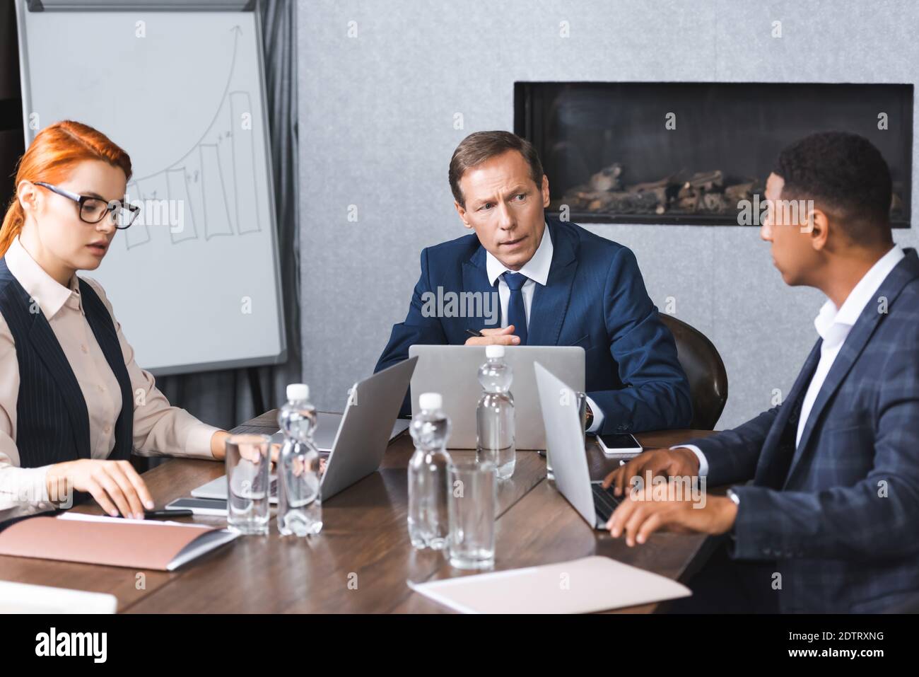 Serious executive talking to african american businessman during ...