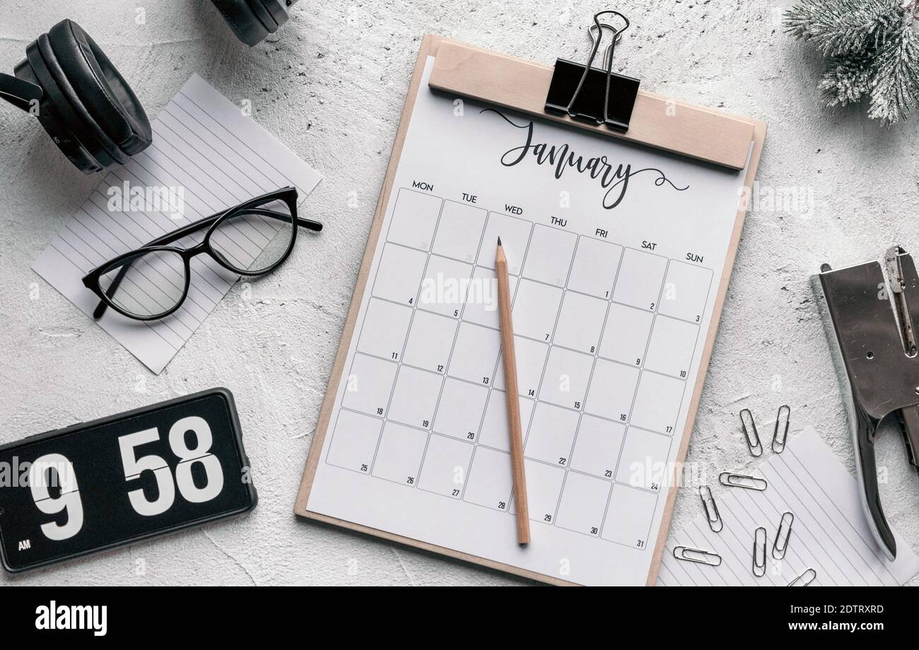 The flat lay of a calendar diary, flip clock screensaver on the phone ...