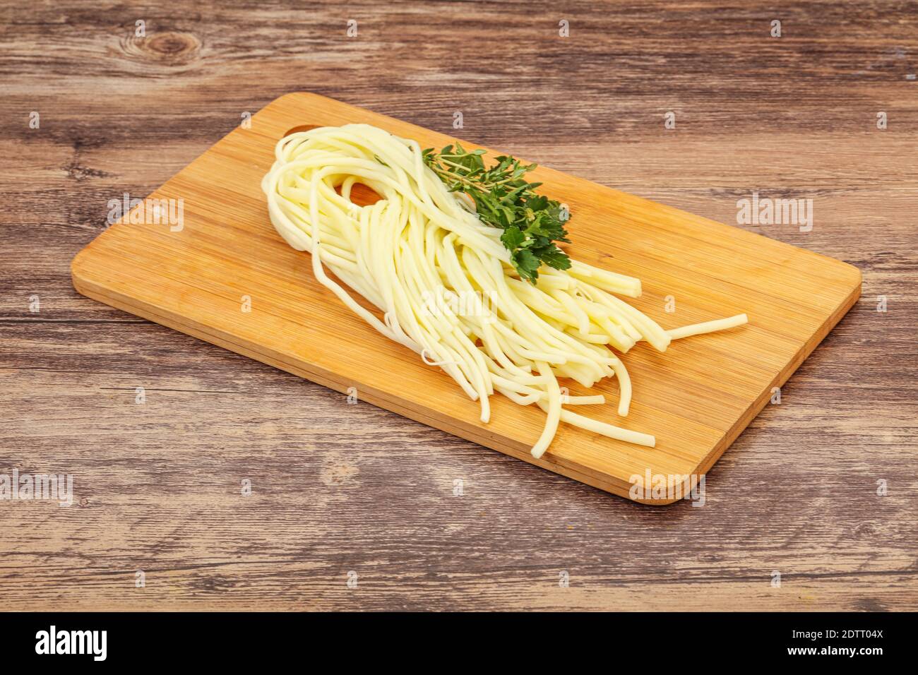 Chechil spaghetti cheese snack over board Stock Photo - Alamy