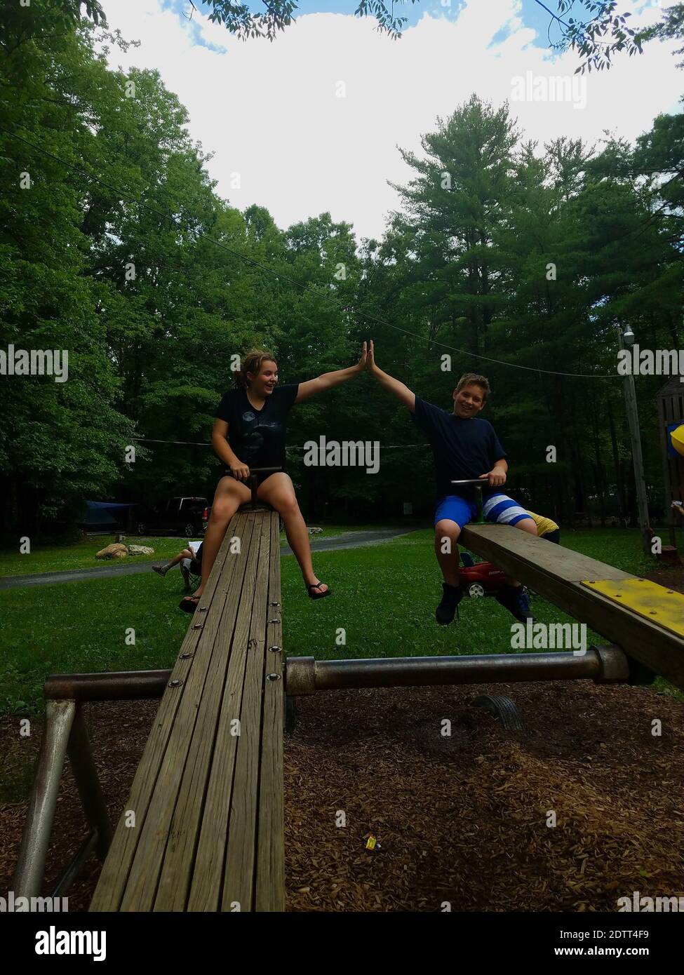 Family sitting on seesaw hi-res stock photography and images - Alamy