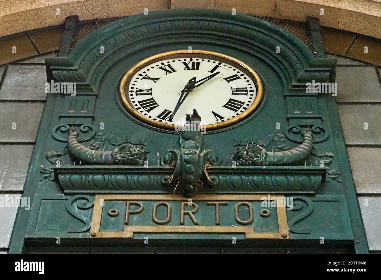 A low angle shot of the famous clock in Sao Bento Railway Station in ...