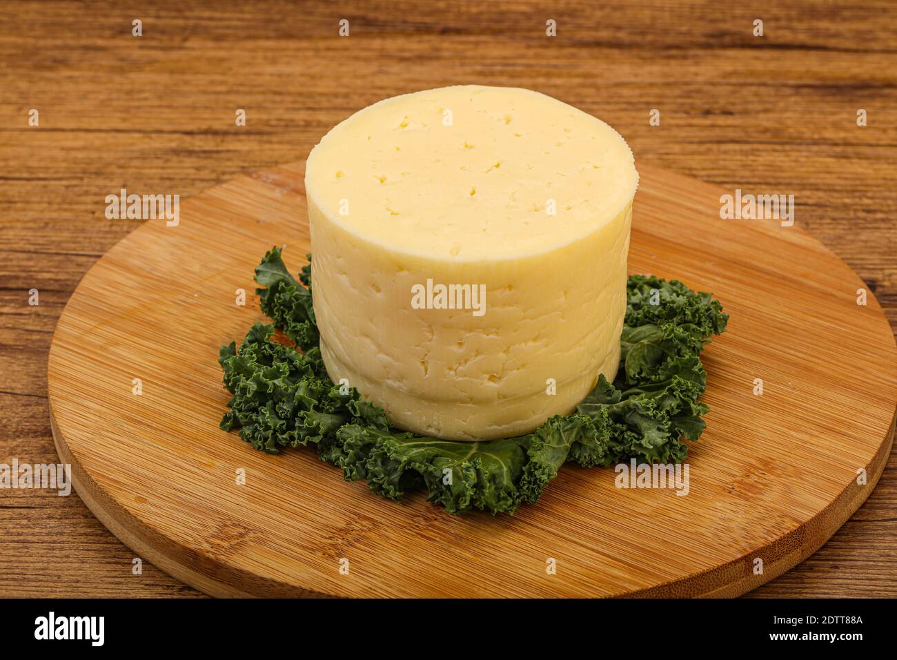 Yellow round dairy soft cheese piece Stock Photo - Alamy