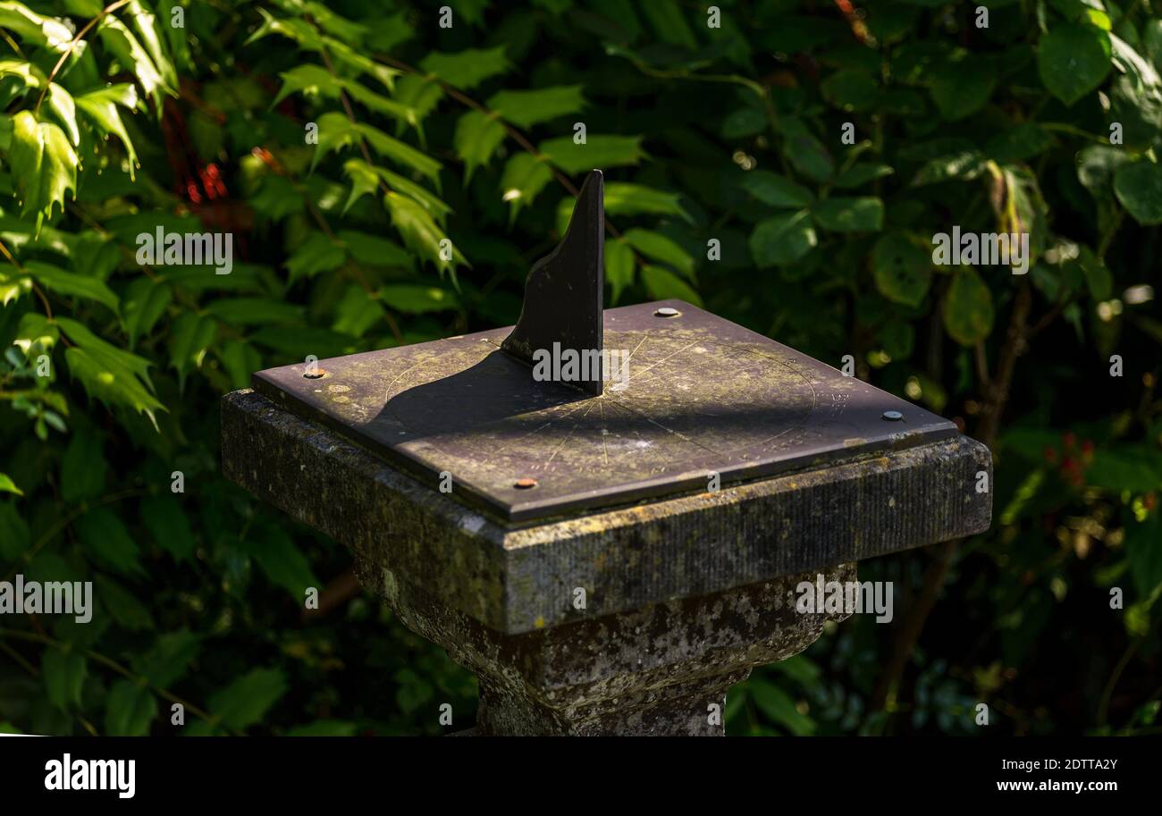 Ancient sundial in the shadows of trees Stock Photo - Alamy