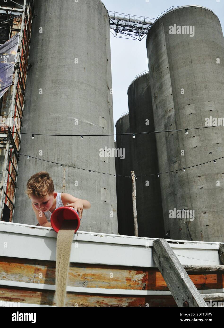 Boy pouring bucket hi-res stock photography and images - Alamy