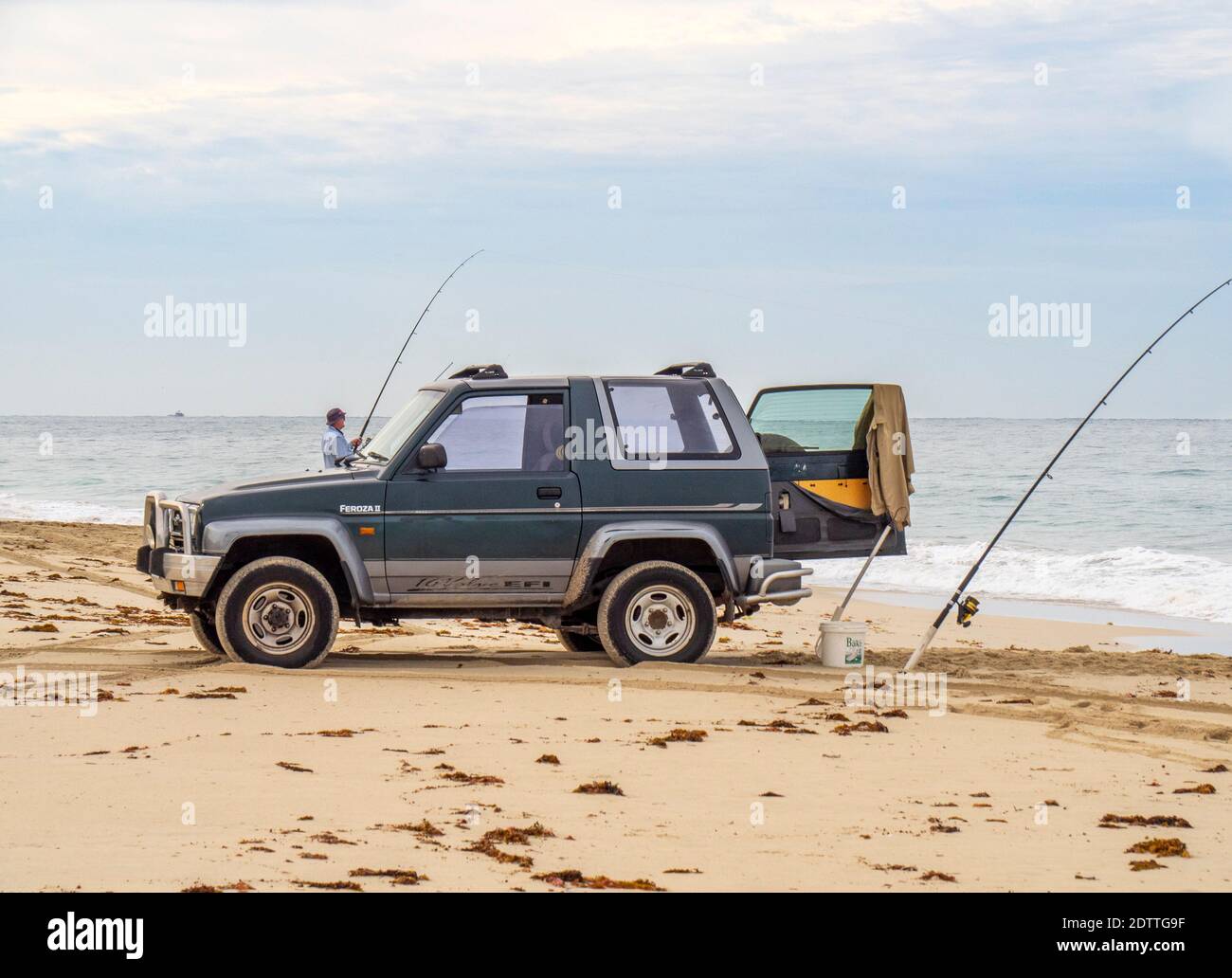 Man beach fishing with fishing rod at Guilderton Western Australia ...