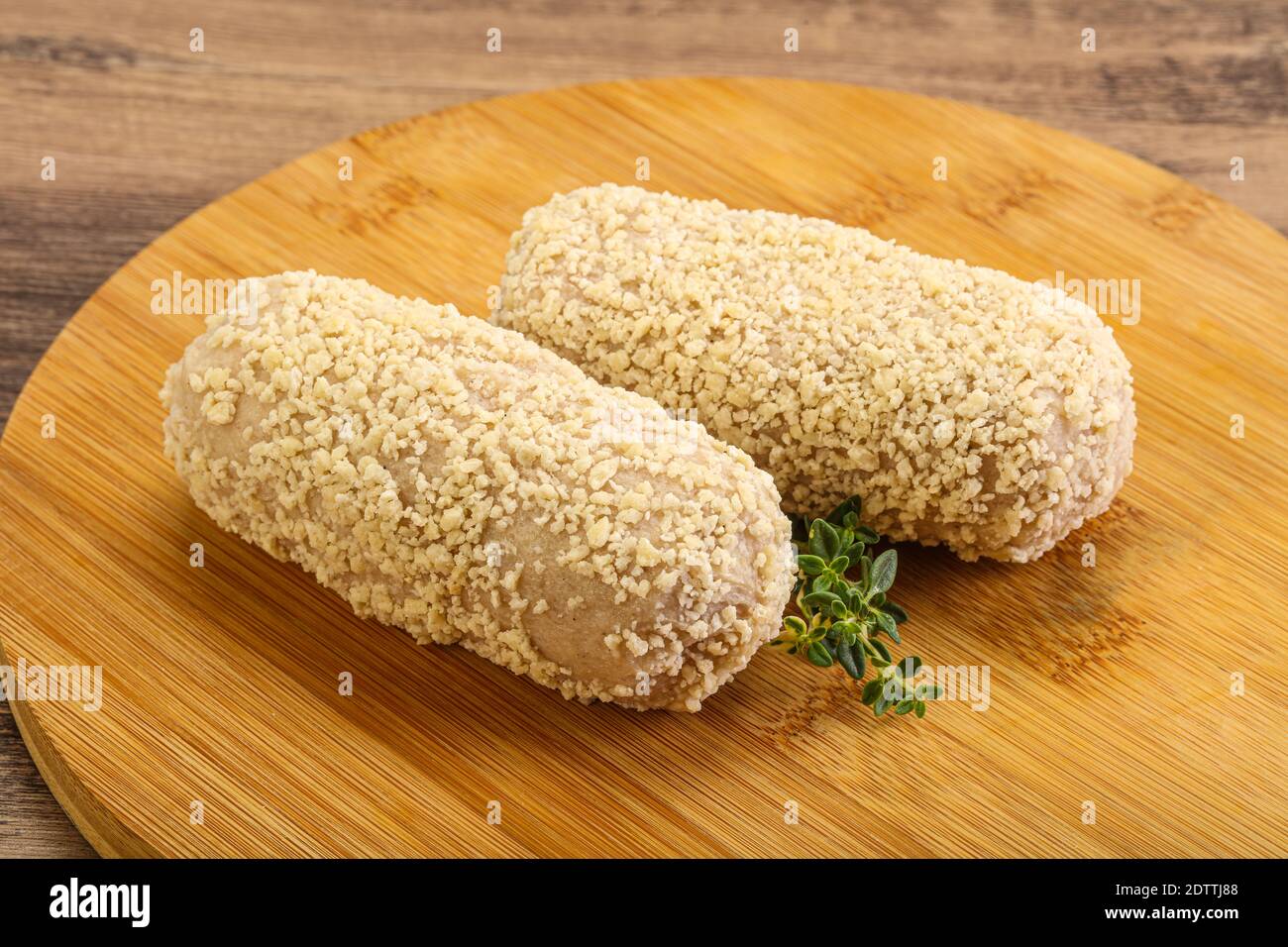Raw breaded chicken cutlet for roast Stock Photo - Alamy