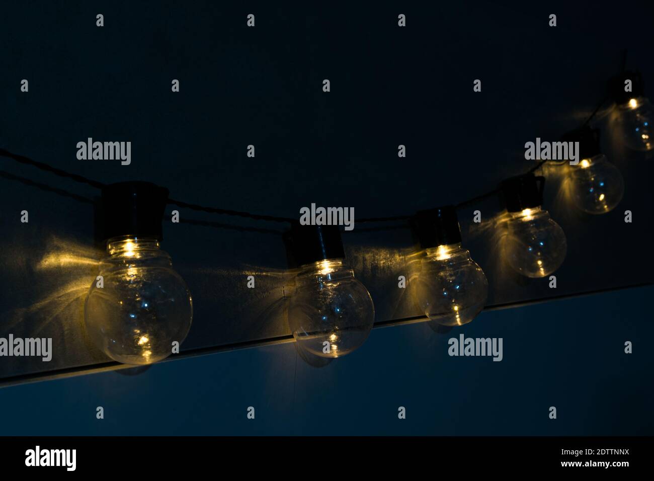 Decoration of lit light bulbs hanging on the wall Stock Photo - Alamy