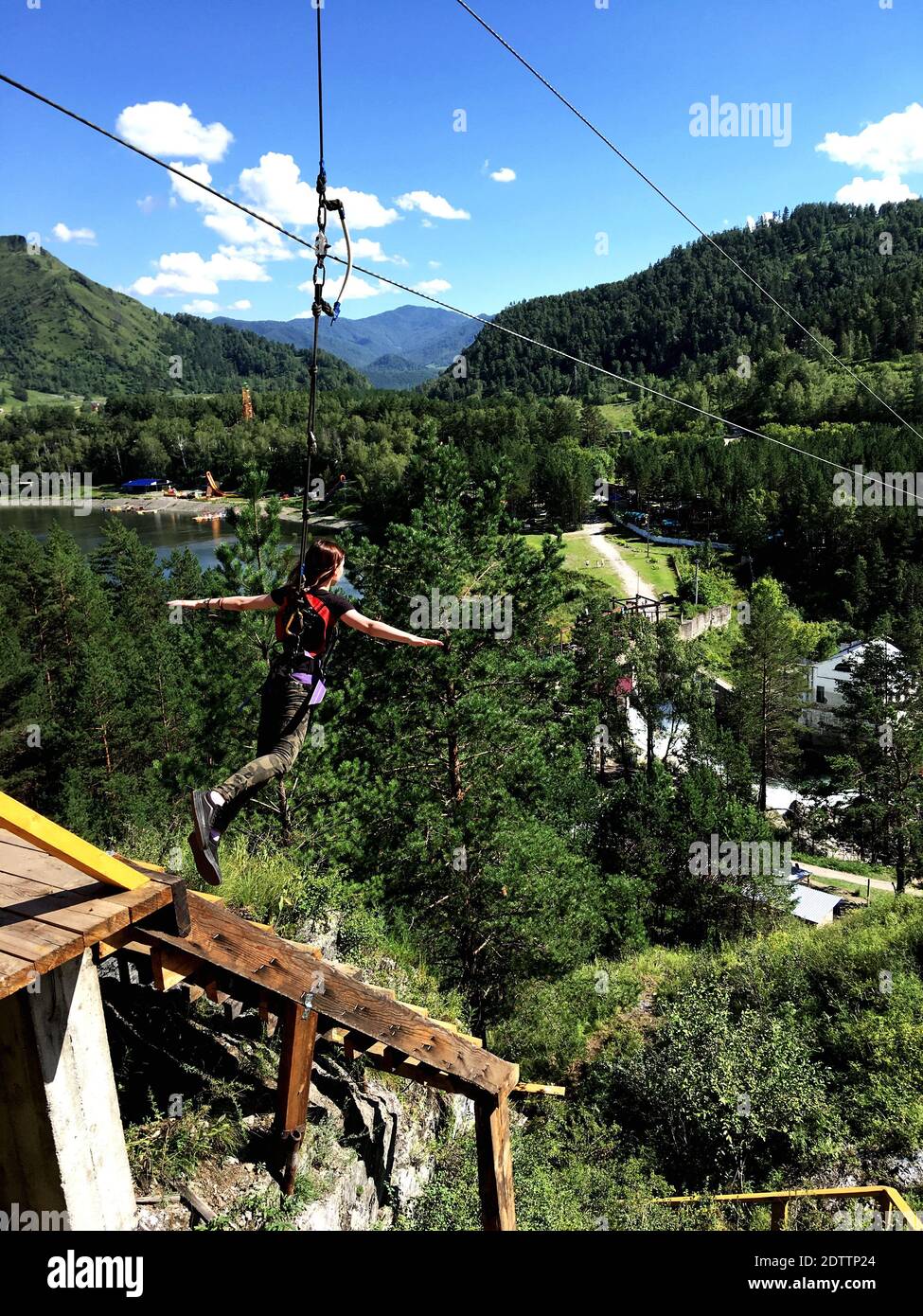 Young woman zip lining hi-res stock photography and images - Alamy