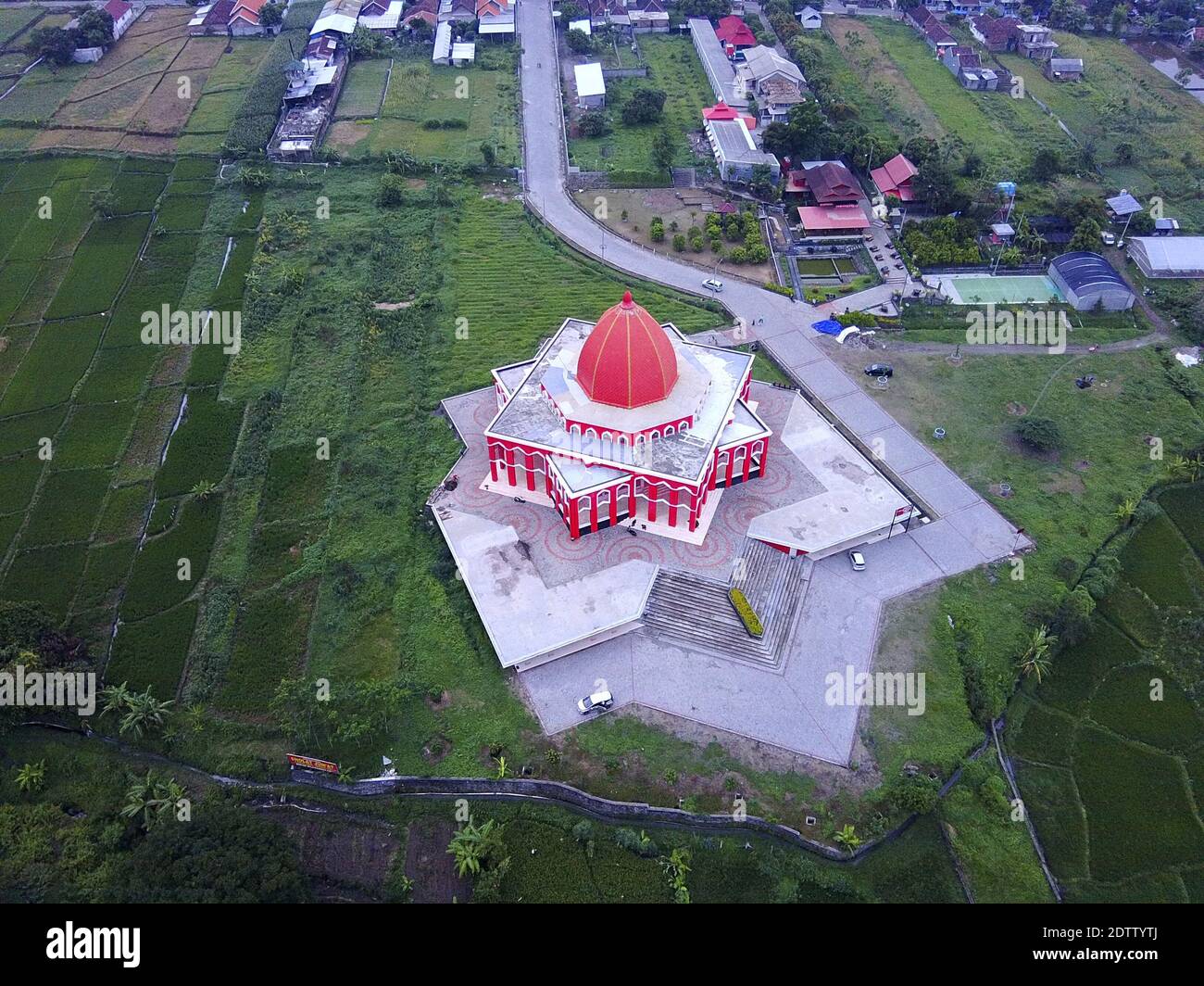 An aerial view of a red Masjid Merah mosque in Indonesia Stock Photo ...