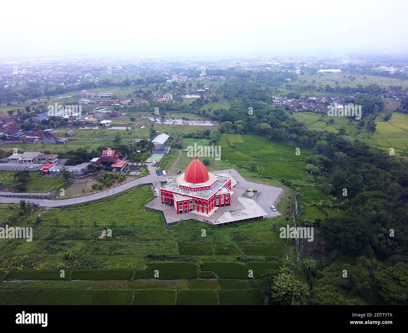 An aerial view of a red Masjid Merah mosque in Indonesia Stock Photo ...