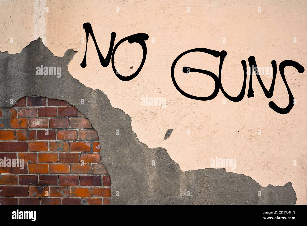 Handwritten graffiti No Guns sprayed on the wall, anarchist aesthetics ...