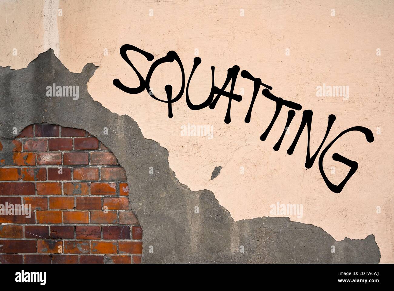 Handwritten graffiti Squatting sprayed on the wall, anarchist ...