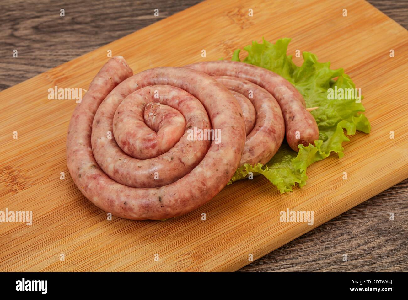 Raw pork sausage ring for grill Stock Photo - Alamy