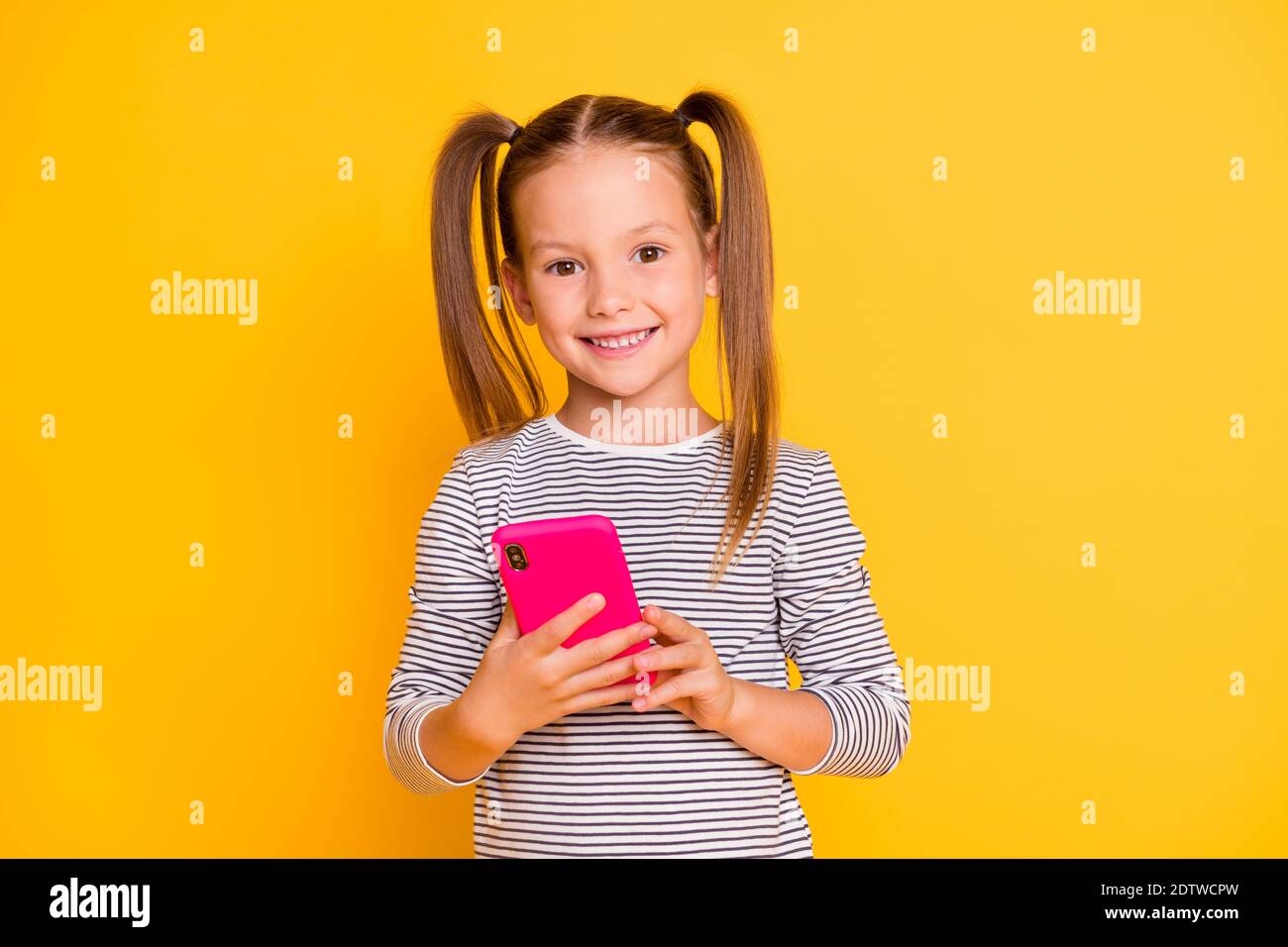 Portrait of young smiling cheerful little girl child kid using phone ...