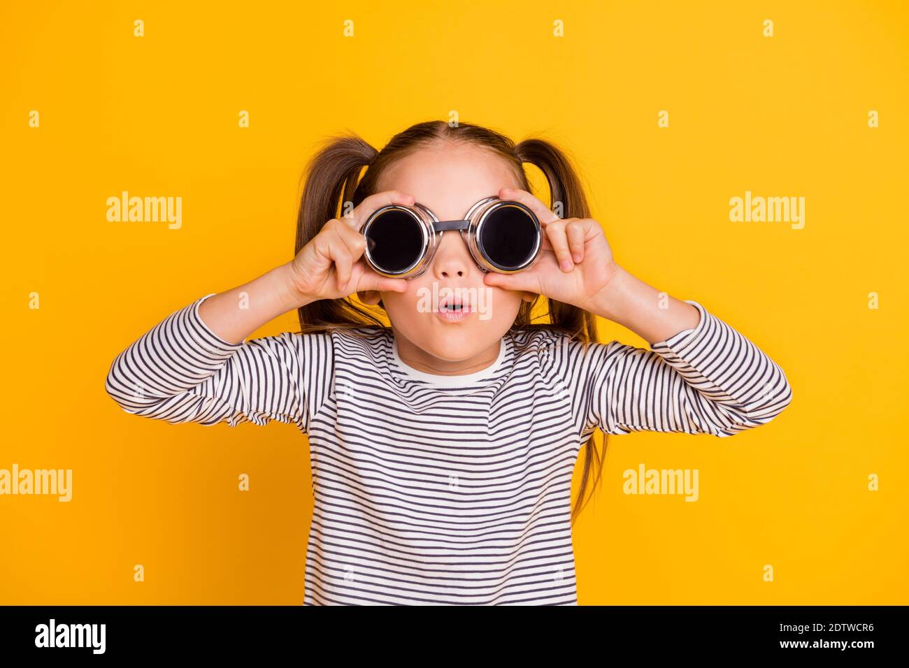 Portrait of young amazed surprised impressed little girl kid child wear ...