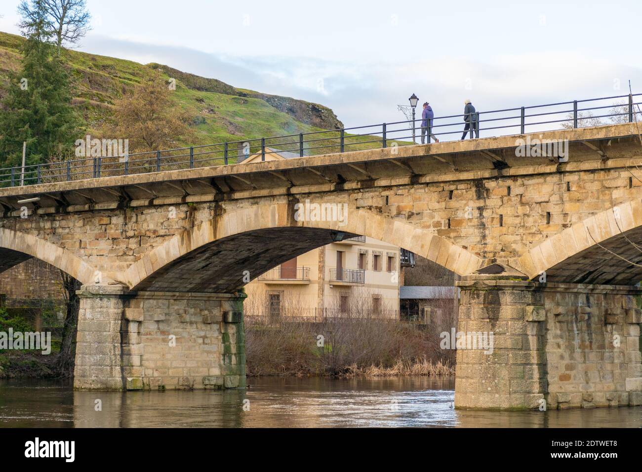 Stone bridge Puebla de Sanabria with people walking in a sunset ...