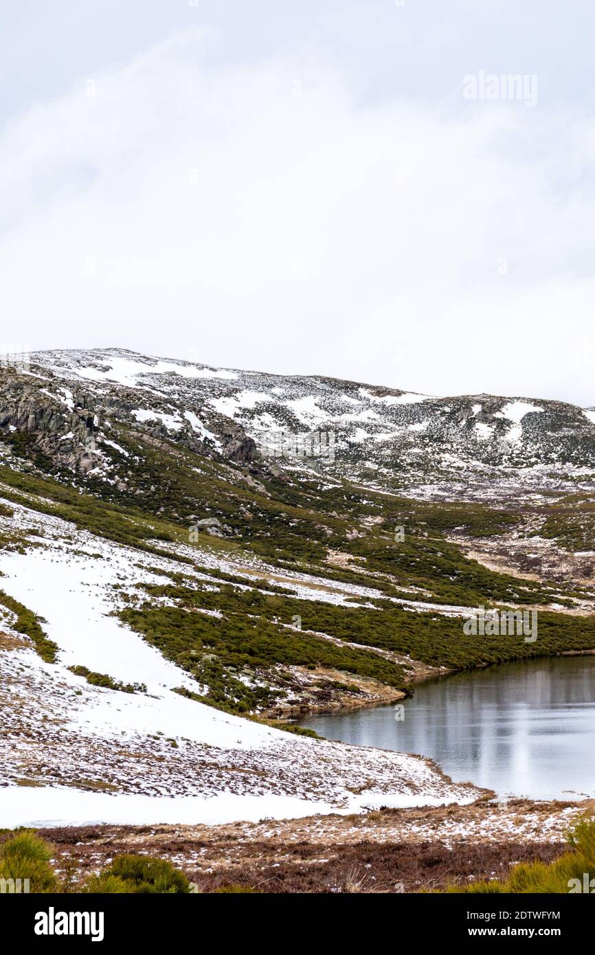 Nice vertical panoramic view of a lagoon with snowy mountains in the ...