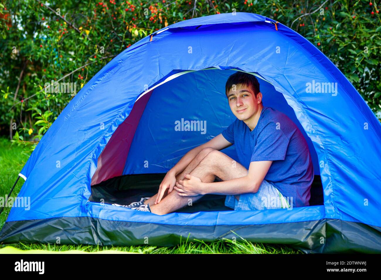 Man in forest with tent hi-res stock photography and images - Alamy