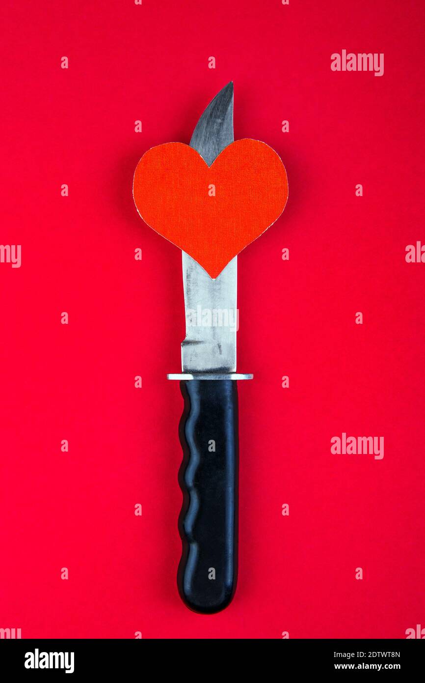 Heart Shape and a Knife on the Red Paper Background Stock Photo - Alamy