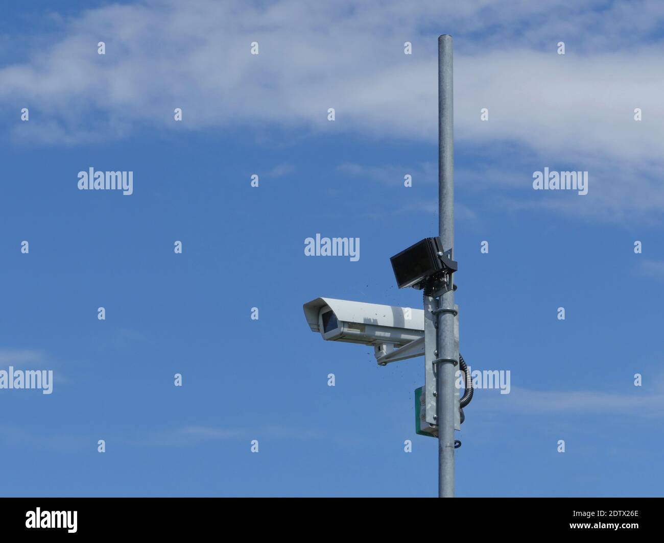 Surveillance camera on a pole high in the blue sky Stock Photo - Alamy