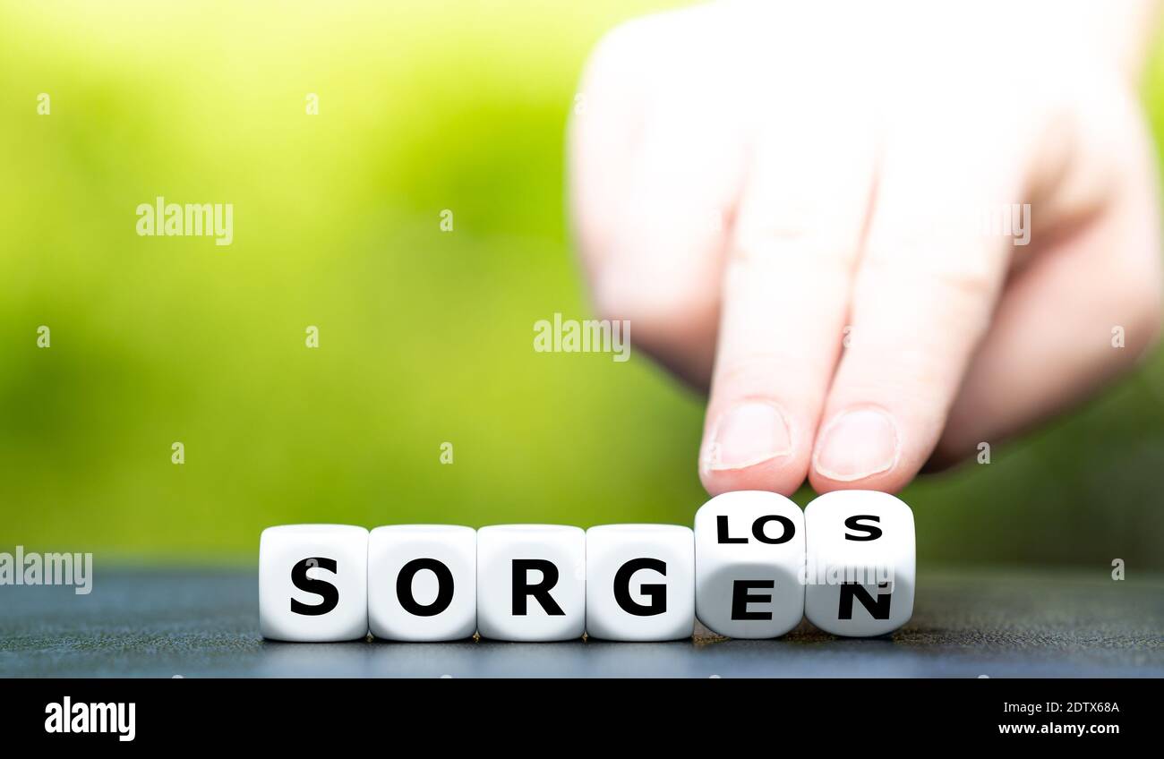 Hand turns dice and changes the German word "Sorgen" (sorrow) to ...