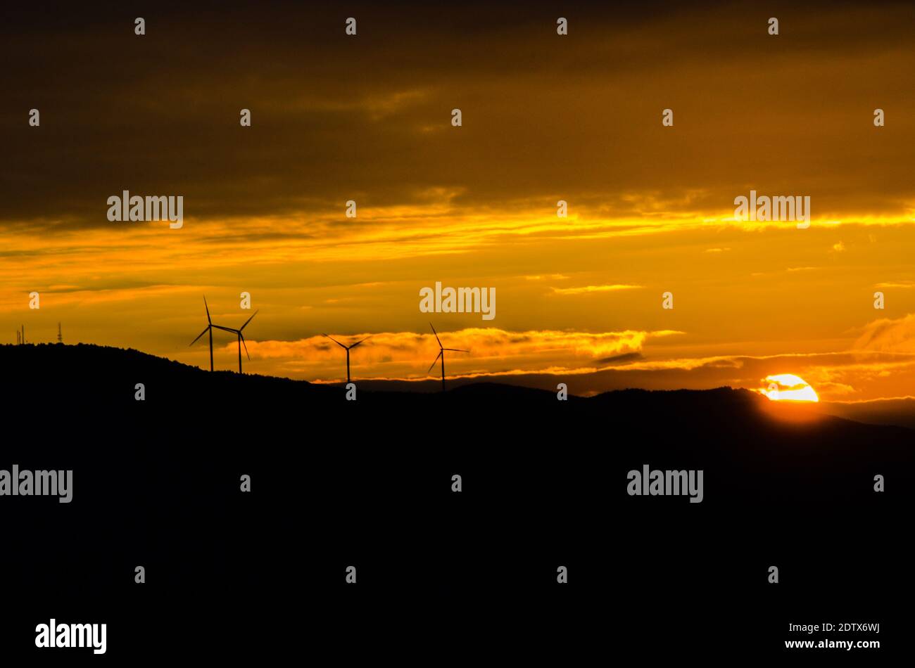 sunset with wind turbines Stock Photo - Alamy