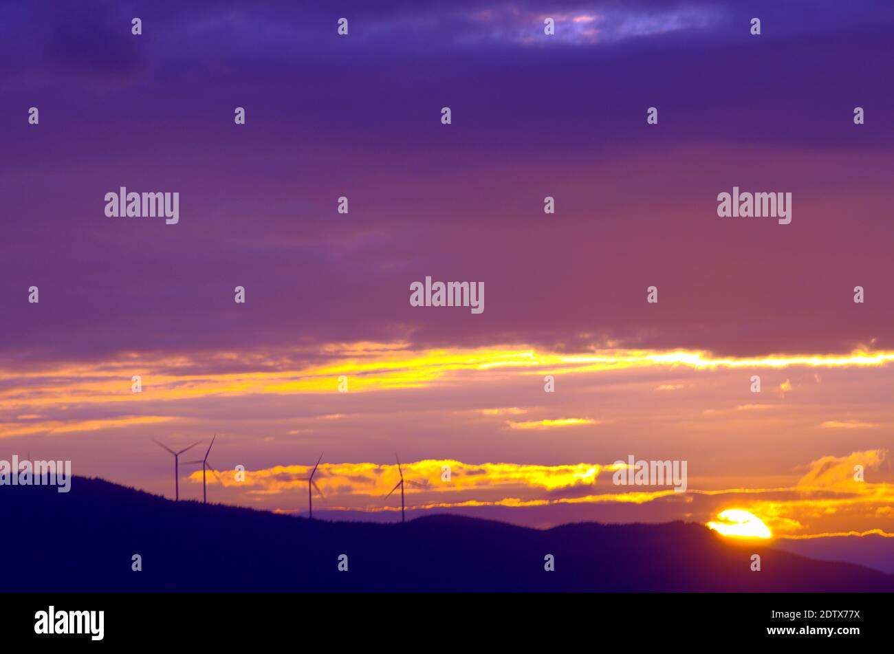 sunset with wind turbines Stock Photo - Alamy