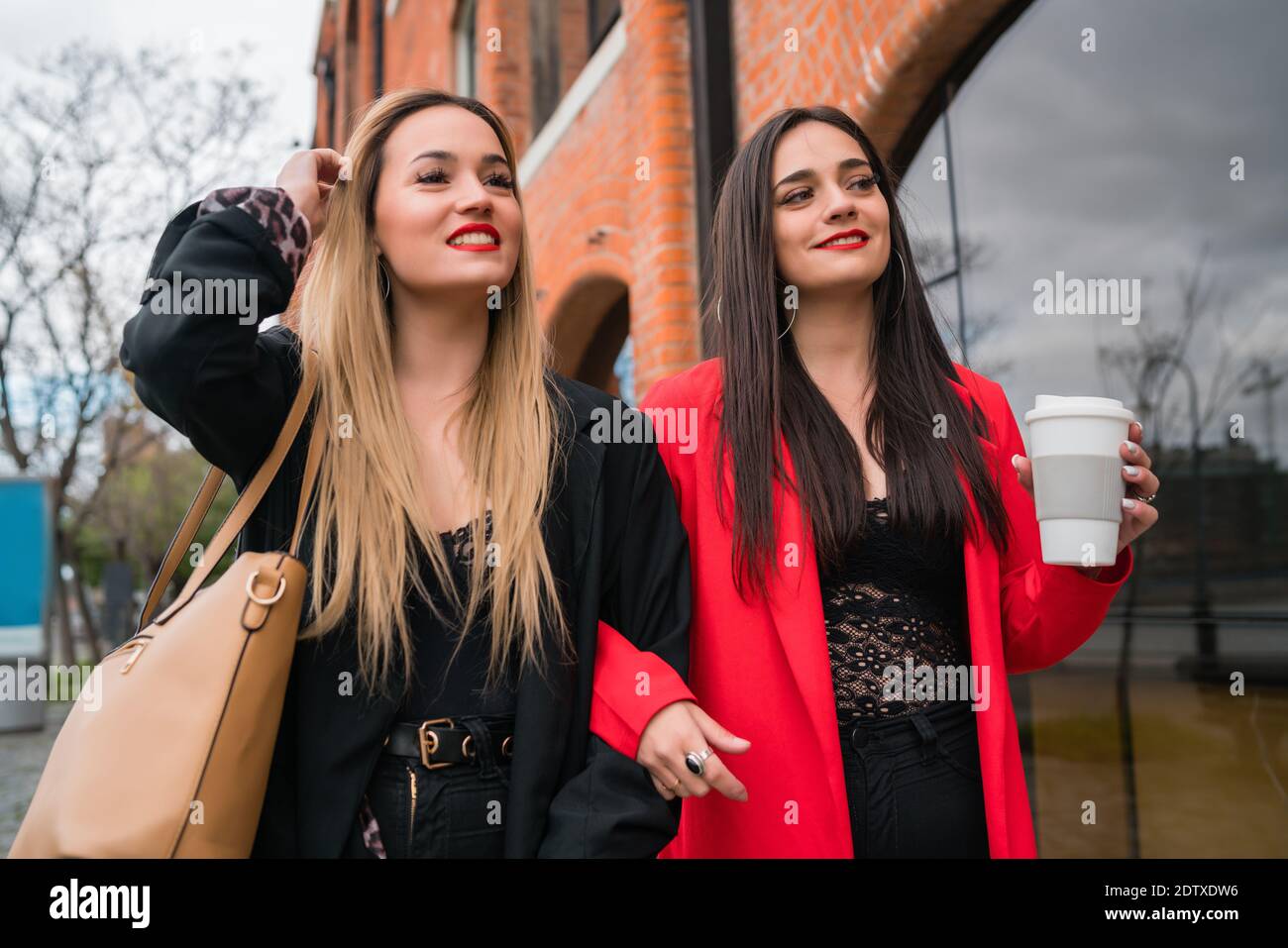 Two young friends walking together outdoors Stock Photo - Alamy