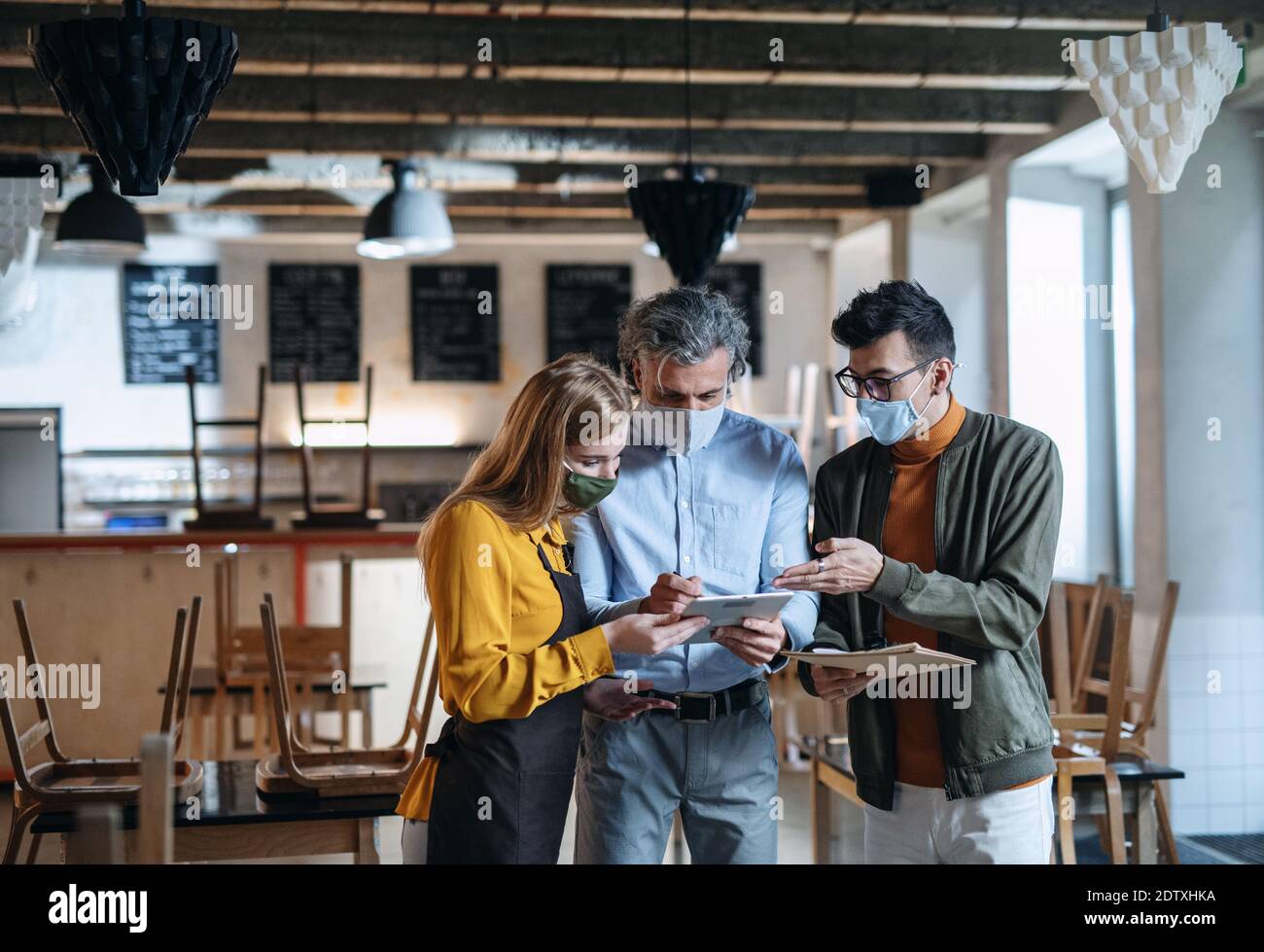 Frustrated owners with waitress in closed cafe, small business lockdown ...