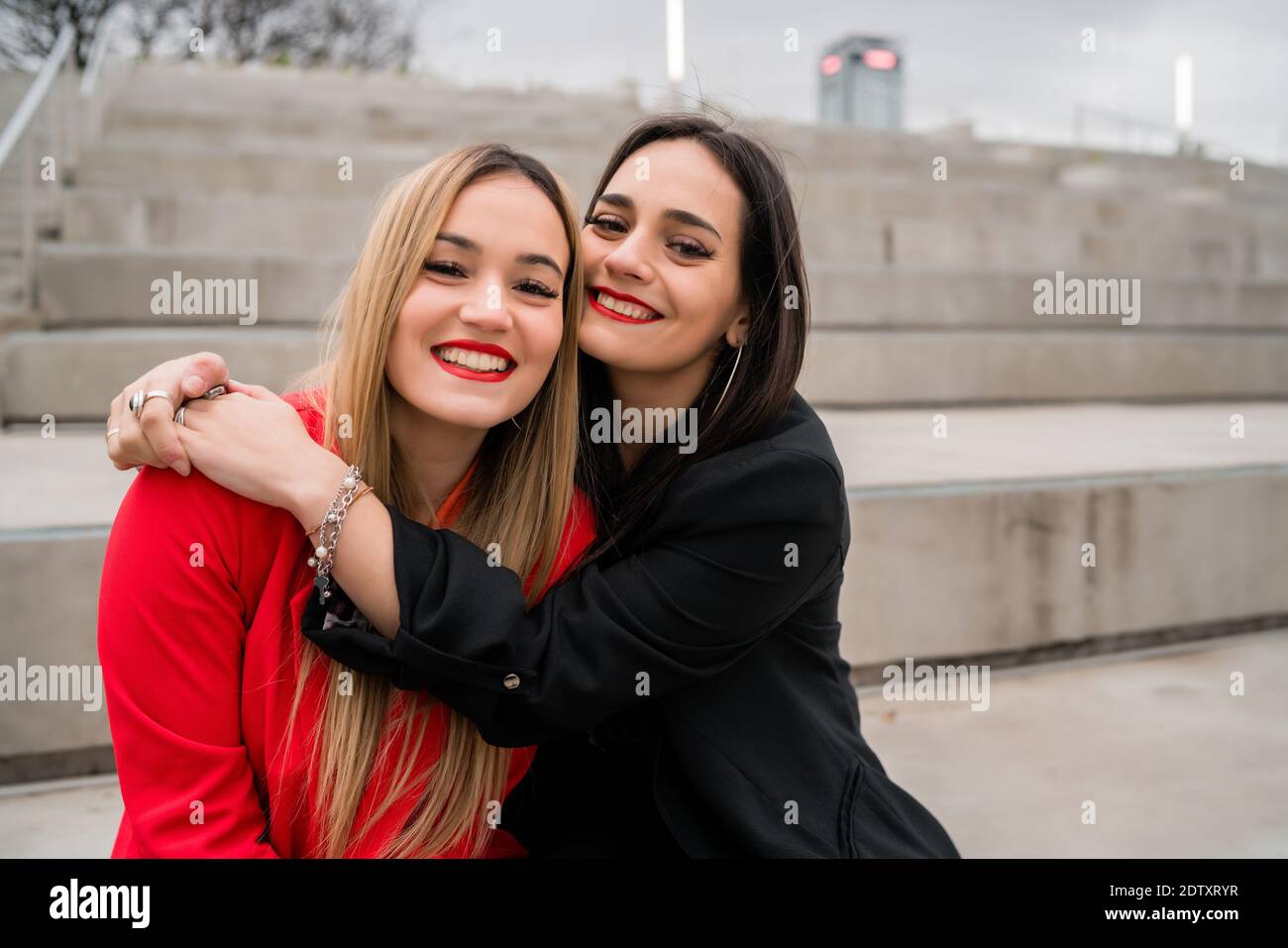 Two young friends hugging each other Stock Photo - Alamy