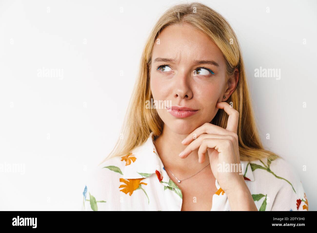 Confused beautiful girl posing and looking aside isolated over white ...