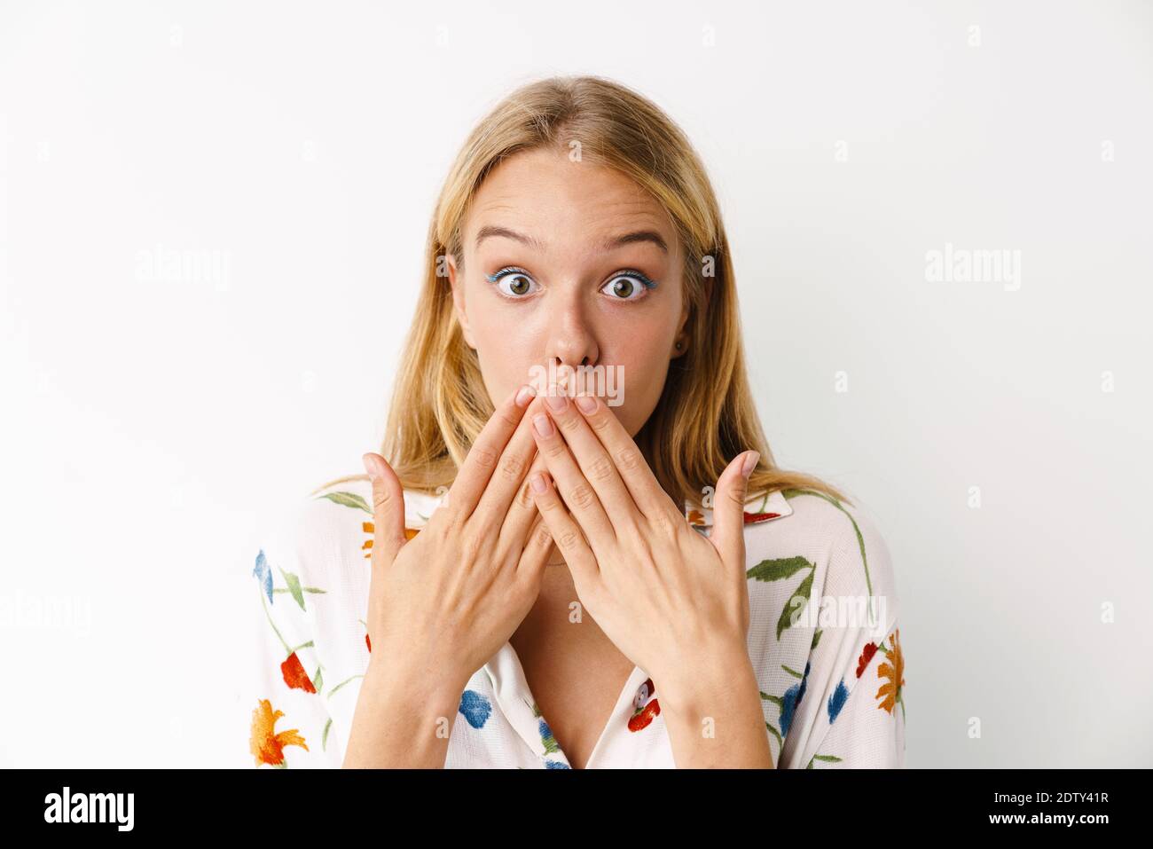Shocked Beautiful Girl Covering Her Mouth While Posing At Camera