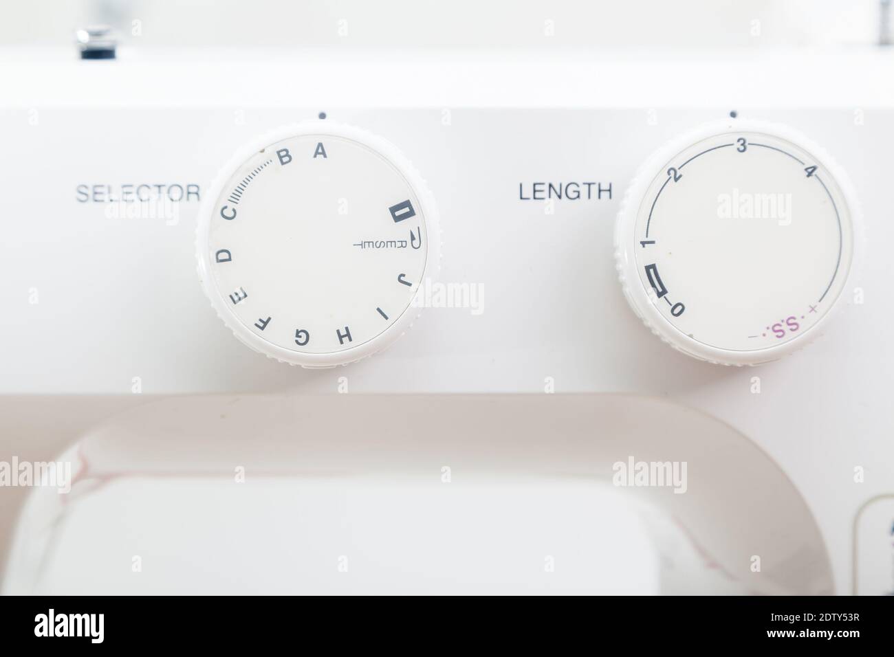 Closeup of mode knobs of sewing machine against white background Stock ...
