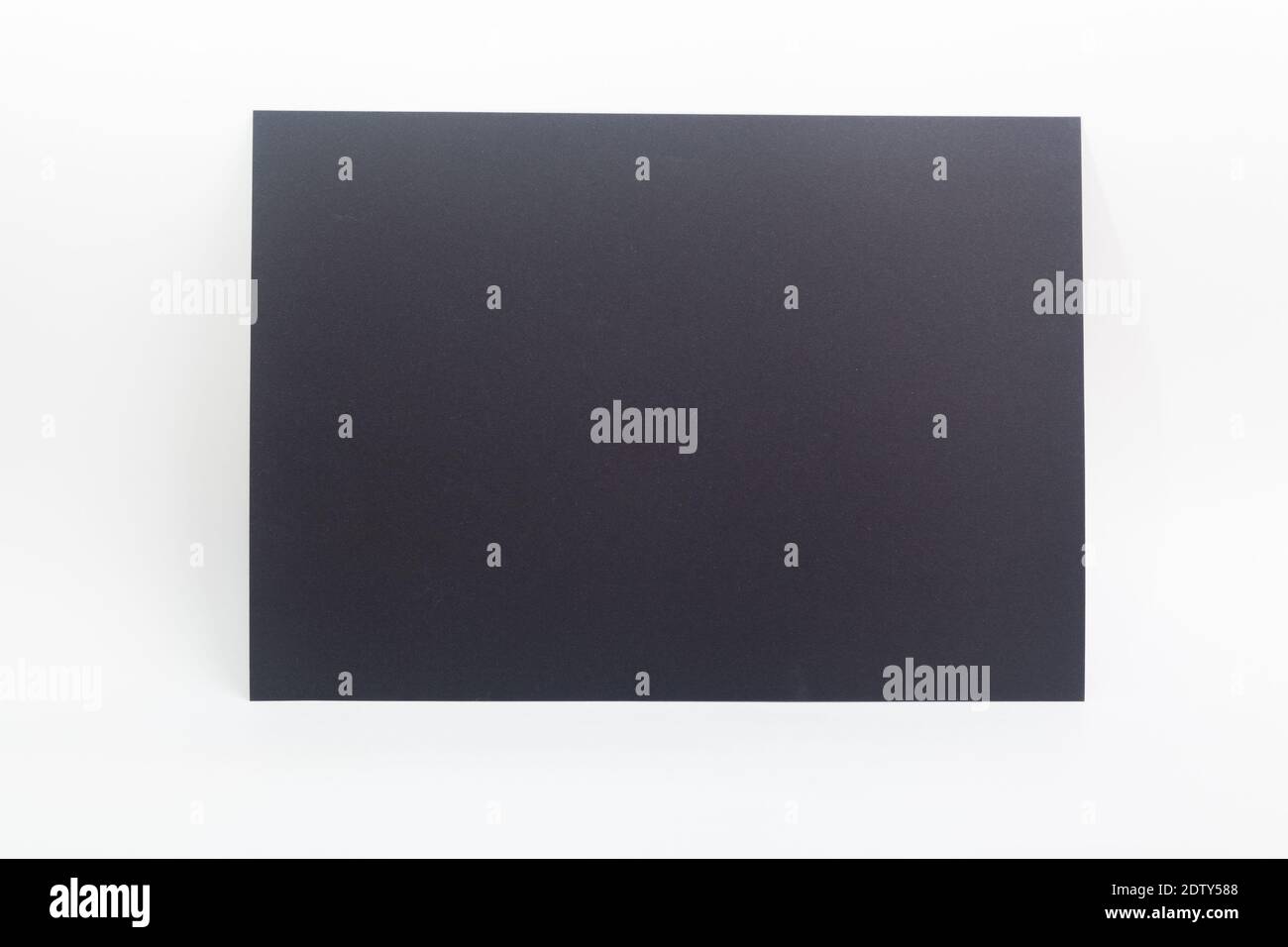 Black paper sheet against white background Stock Photo - Alamy