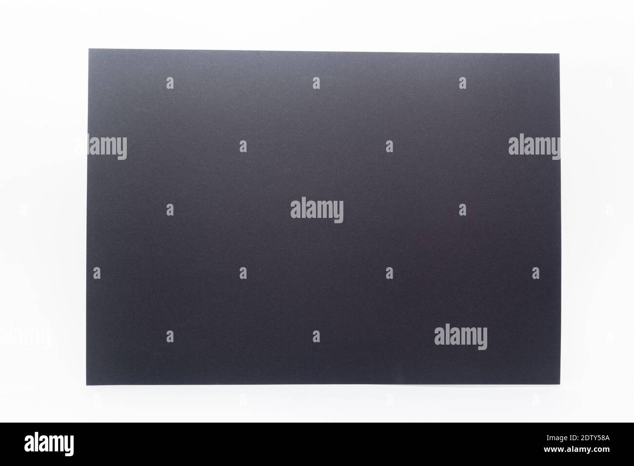 Closeup of black paper sheet against white background Stock Photo - Alamy