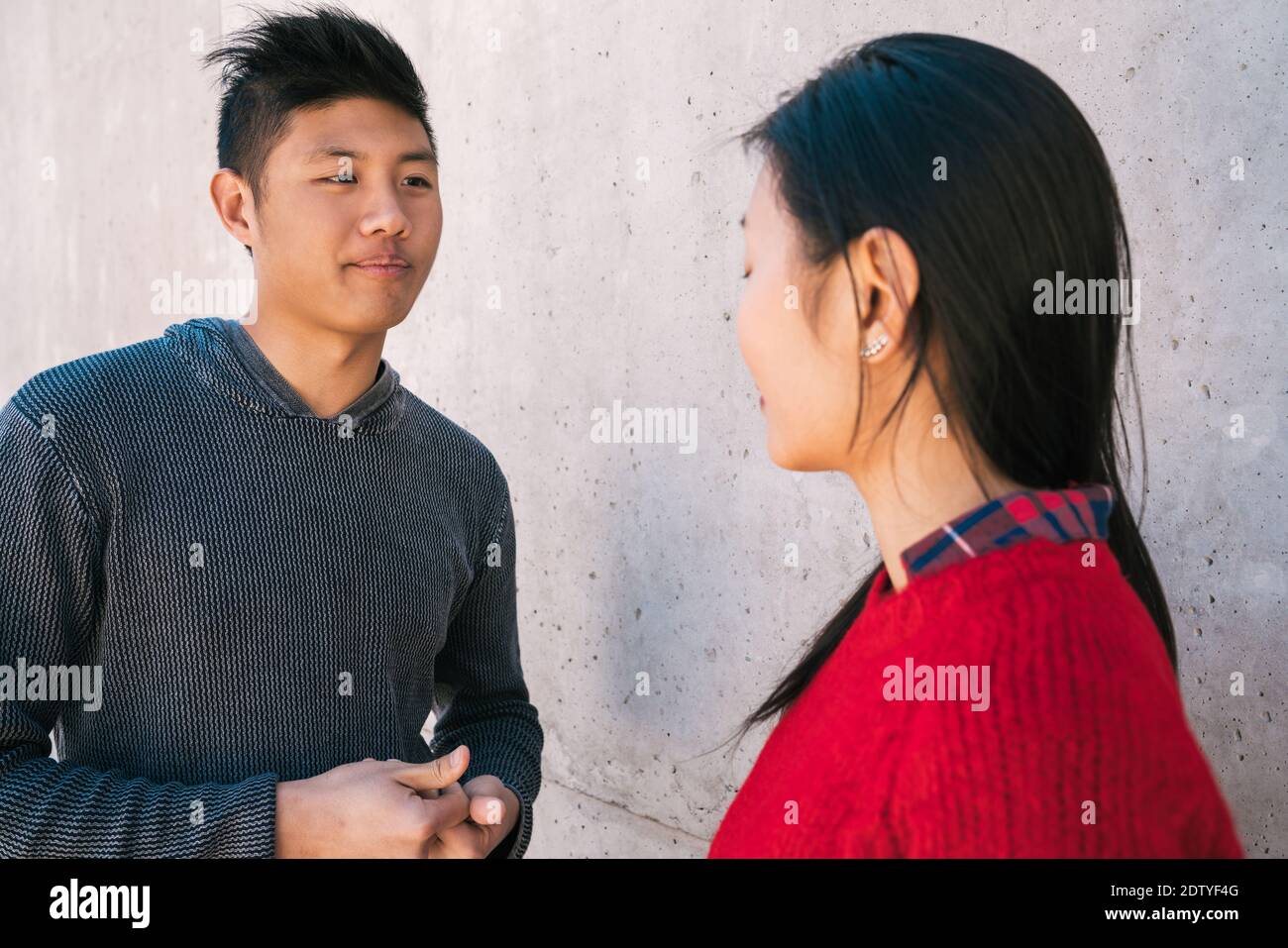 Asian couple having a conversation Stock Photo - Alamy