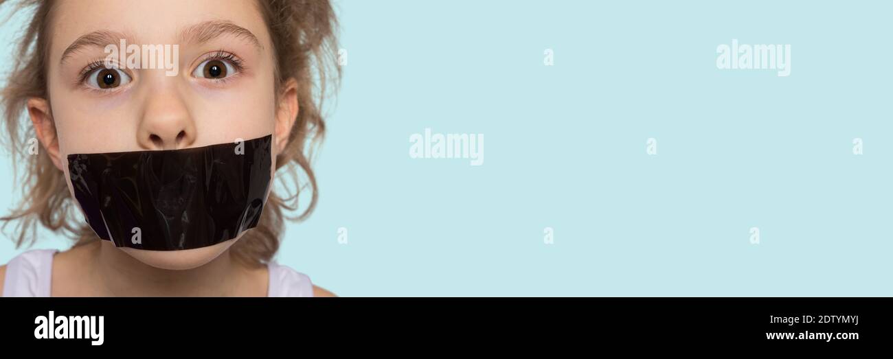 Young girl with taped mouth. Isolated on gray background Stock Photo ...