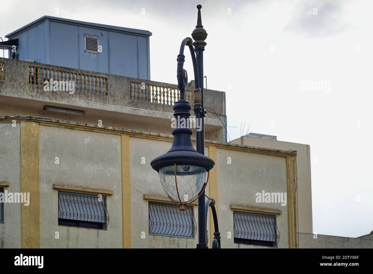 A horizontal shot of a street lamp in front of a building under the sky ...