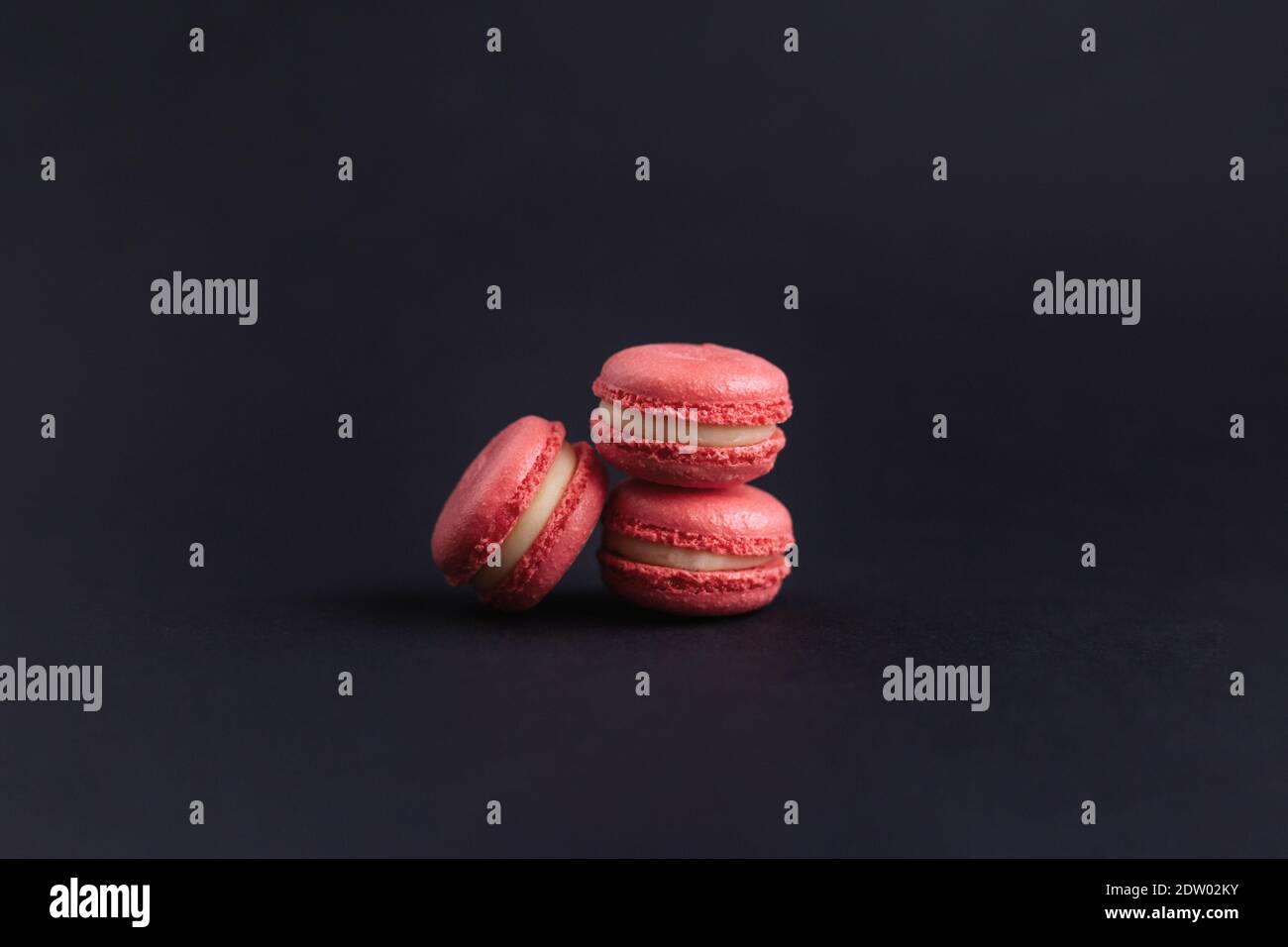 Tasty pink french macaroons on a dark background. Place for text Stock ...