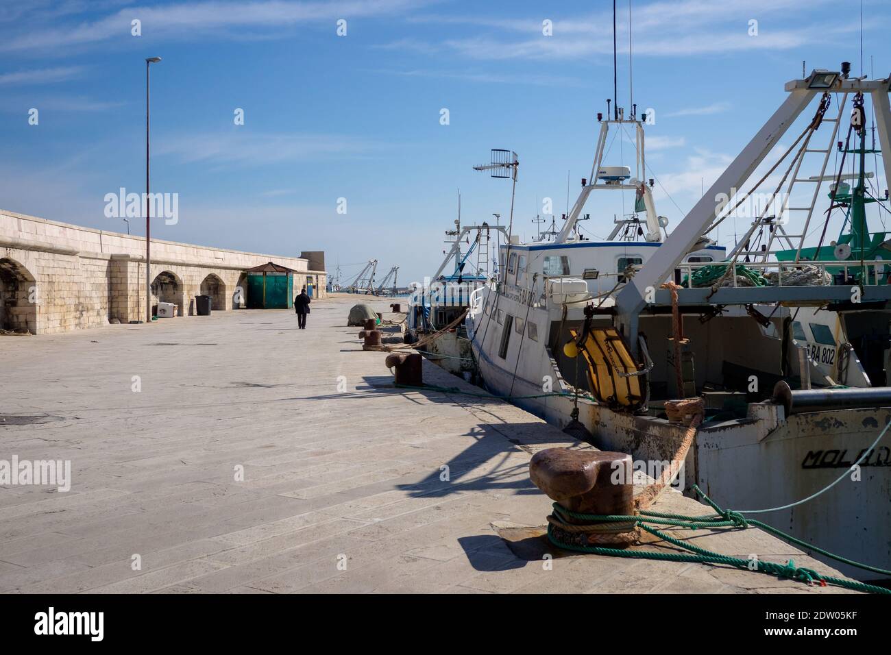 MOLA DI BARI, ITALY, ITALY - FEBRUARY 21, 2016: Old man walks along the ...