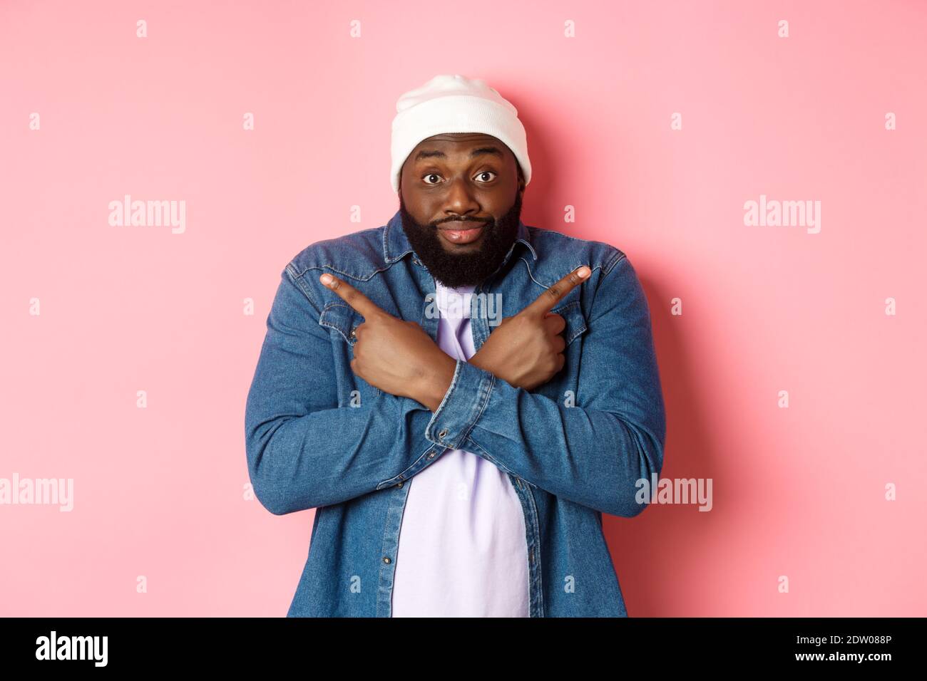 Confused Black man asking help with choice, pointing sideways and ...