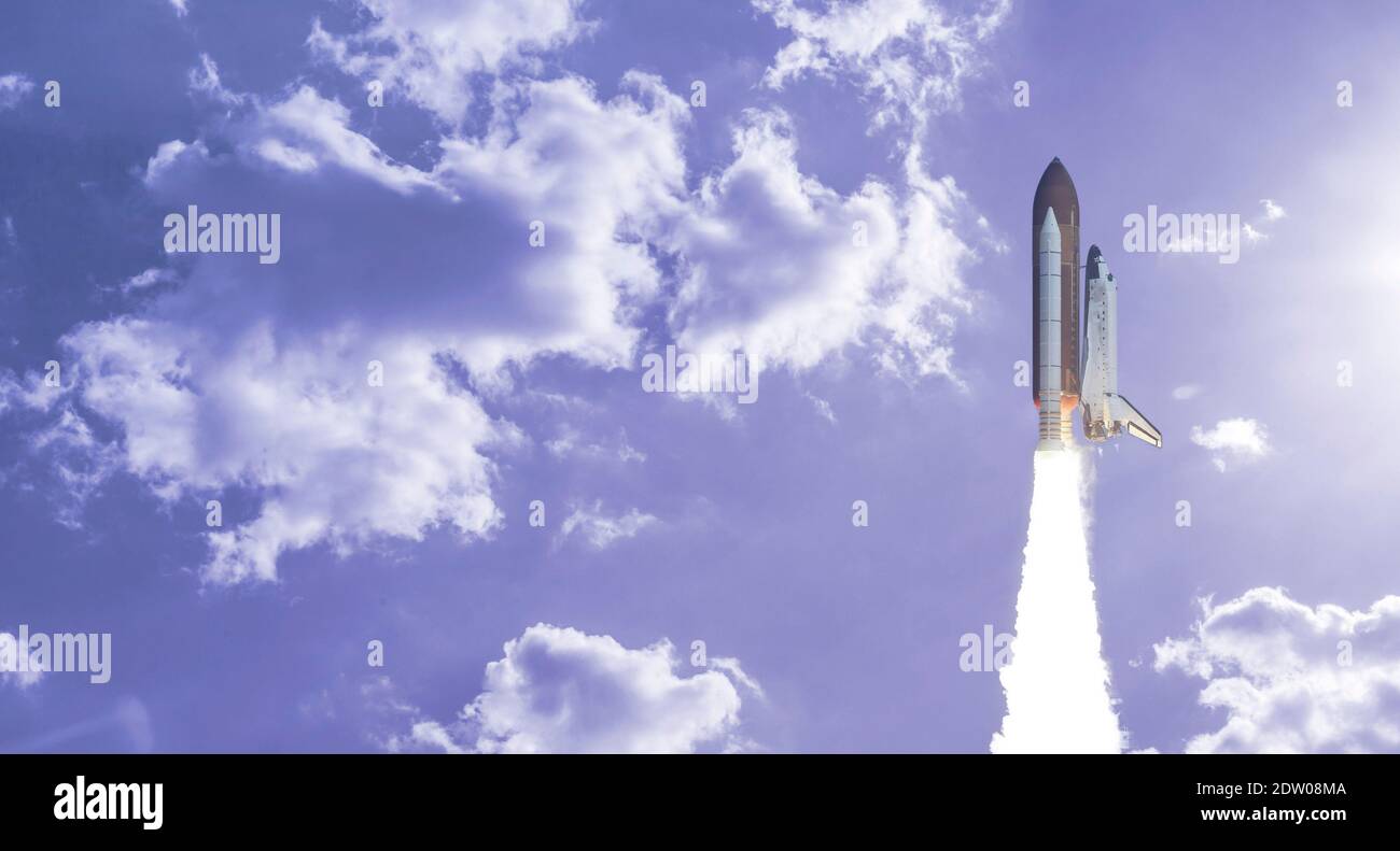 the spaceship rocket shuttle in the cloudy sky fly up high to the space ...
