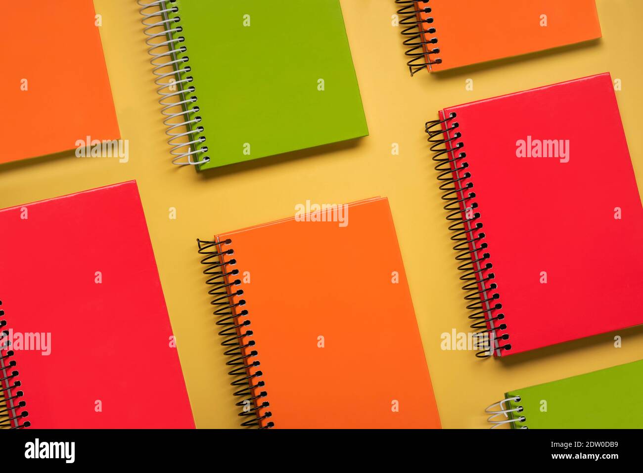 Geometric pattern made with colorful spiral notepads on a yellow ...