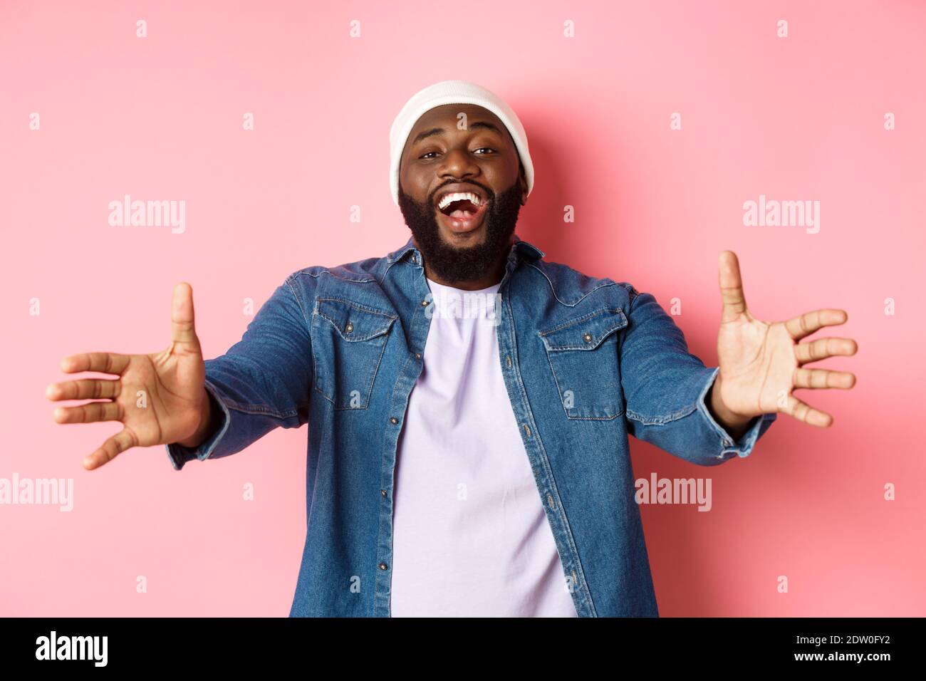 Happy Black man stretching hands, reaching for hug or take something ...